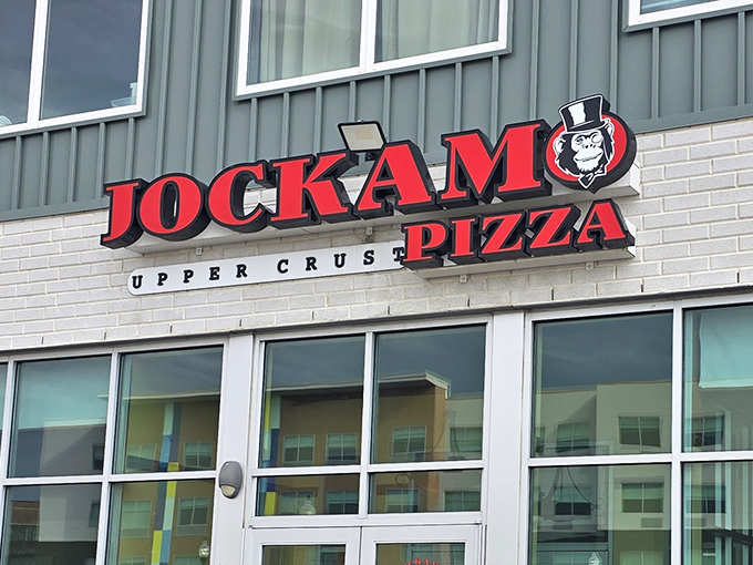 Jockamo's bold red signage announces its pizza mission with confidence – no need to whisper when your crust speaks volumes.