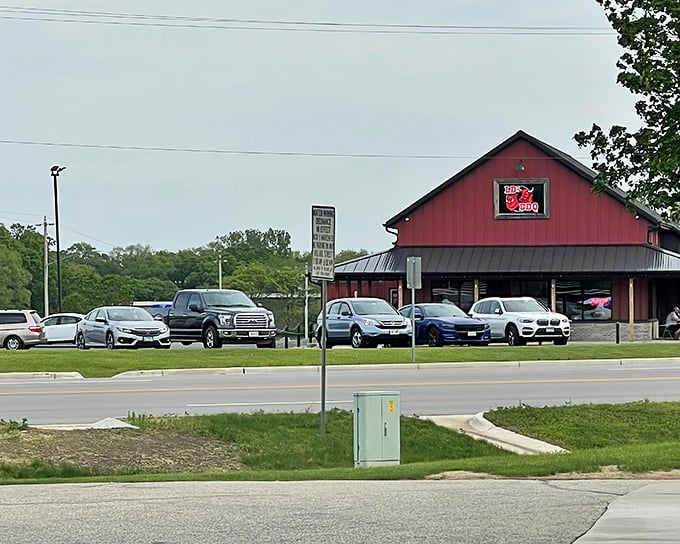 The classic red barn of LD's BBQ stands proud against the Wisconsin sky – a beacon for hungry travelers.