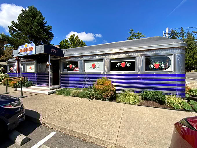 Classic Americana gleams in this vintage diner's polished chrome and bold blue stripes – a time capsule serving breakfast.