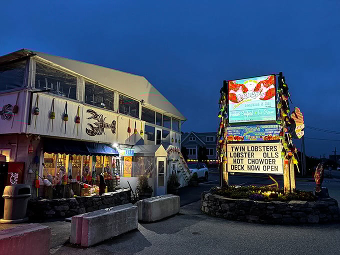 Petey's at twilight – where colorful buoys and twinkling lights transform a simple building into seafood magic after dark.