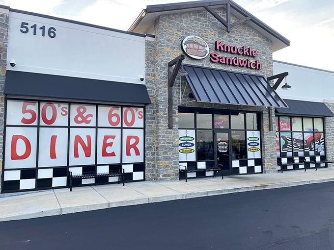 Retro vibes and modern bites! The Knuckle Sandwich's black-and-white checkered facade is like stepping into a time machine where the 50s and 60s meet today's gourmet sandwich scene.