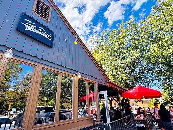 The Park Café's blue cottage exterior whispers "neighborhood secret" louder than any fancy restaurant sign ever could.