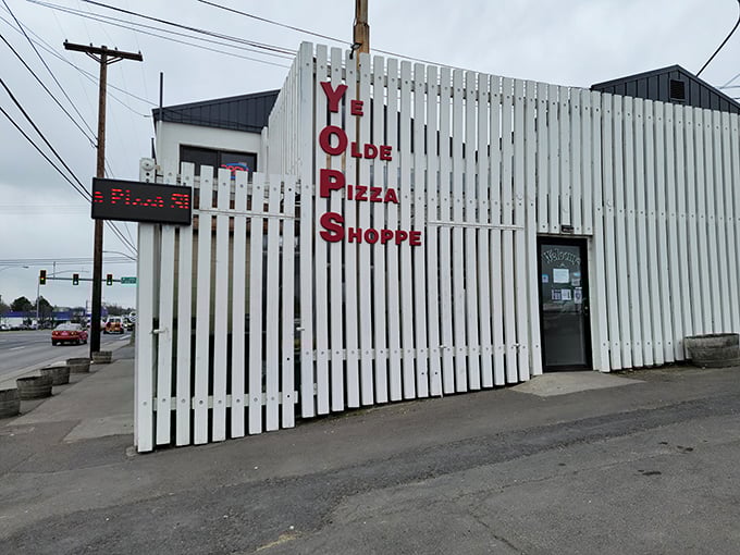 Don't judge this white building by its modest cover – inside lies pizza magic that rivals any big city.