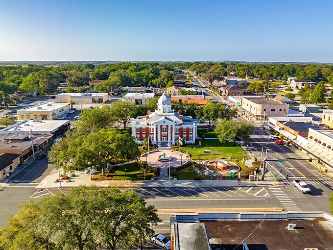 The courthouse stands proud in this charming town where time moves slower than your grandma's ceiling fan on a summer day.