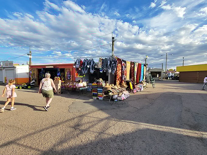 Textile heaven under the Tucson sky! Vibrant fabrics and straw hats beckon shoppers like a desert mirage—except this colorful oasis is delightfully real.