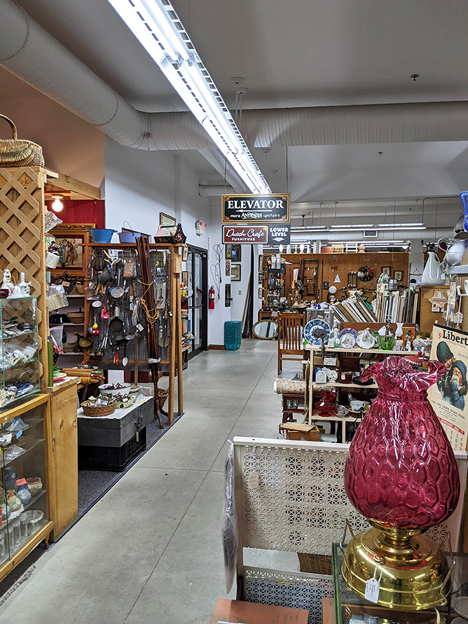 Every aisle tells a story – this one featuring a stunning cranberry glass lamp that would make even the most minimalist decorator suddenly develop an urgent need for vintage lighting.