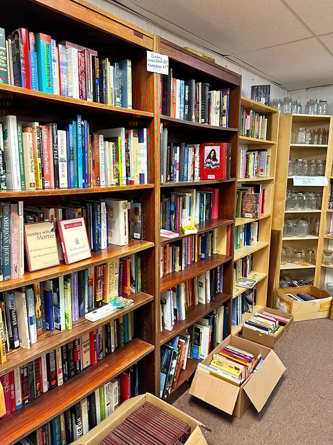 Bookworm heaven awaits between these wooden shelves. Literary treasures organized just enough to make browsing an adventure rather than a chore.