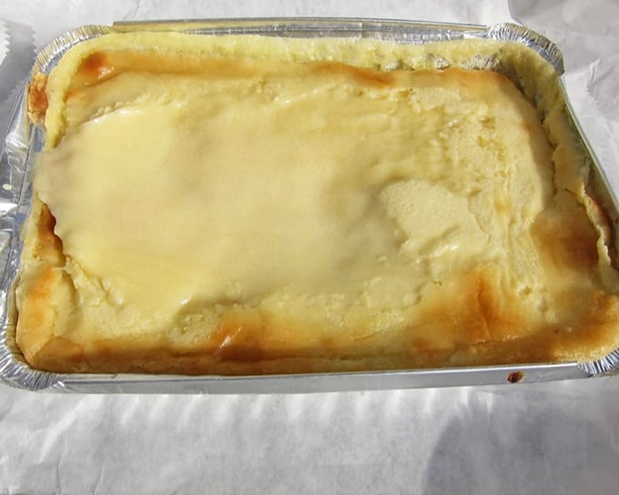 The legendary buttercake in all its golden glory—a simple aluminum pan holding what might be Pennsylvania's most perfect dessert.