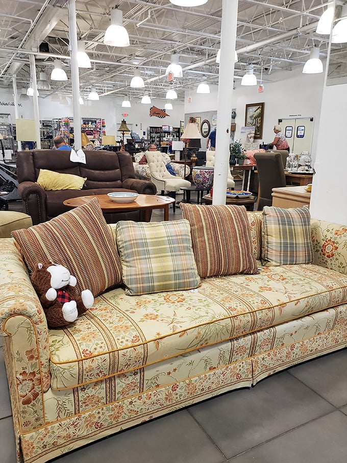 This floral sofa isn't just furniture—it's a time machine to Grandma's living room, complete with plaid pillows and nostalgic comfort.