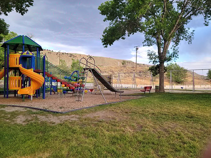Every small town needs a good playground where kids can burn energy while parents contemplate the surrounding mesas. Helper delivers with slides and swings against nature's backdrop.