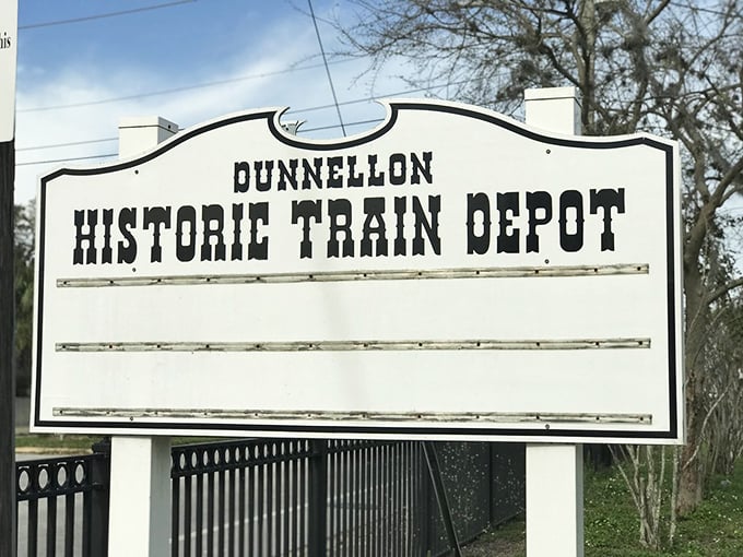 The Dunnellon Historic Train Depot sign stands as a reminder that this town was once a bustling crossroads—now it's where hurried lives come to a peaceful halt.