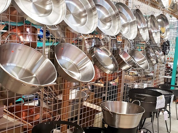 Pots and pans hanging like metallic stalactites in a cave of culinary possibilities. One could feed an army—or just impress the in-laws—with these professional-grade vessels.