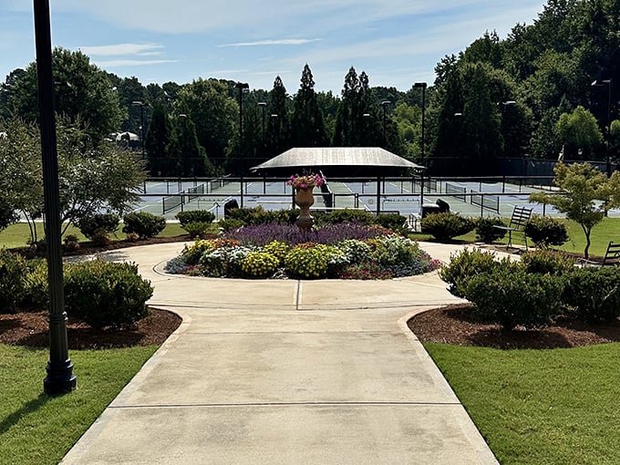 Meticulously landscaped gardens surround the tennis courts, proving that retirement communities and country clubs have become delightfully indistinguishable.