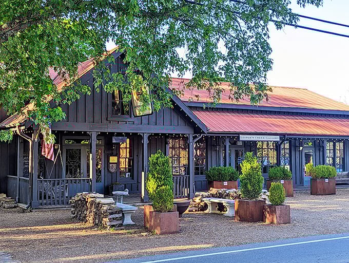That gorgeous black barn with rustic red roof isn't just a building—it's practically the unofficial welcome committee to Leiper's Fork.