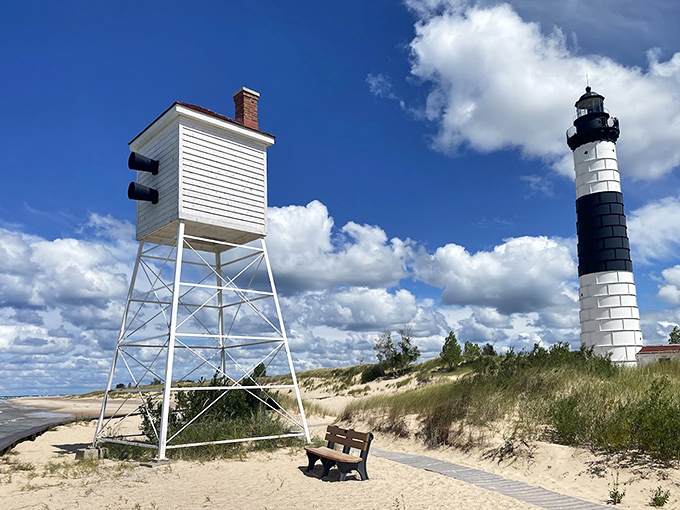 The lighthouse and its companion signal tower stand guard together—like maritime's odd couple, one tall and elegant, the other squat but equally important.