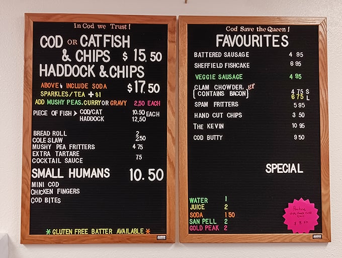 "In Cod We Trust" isn't just clever wordplay—it's a mission statement. This menu board's "Small Humans" section proves British humor travels well across the pond.