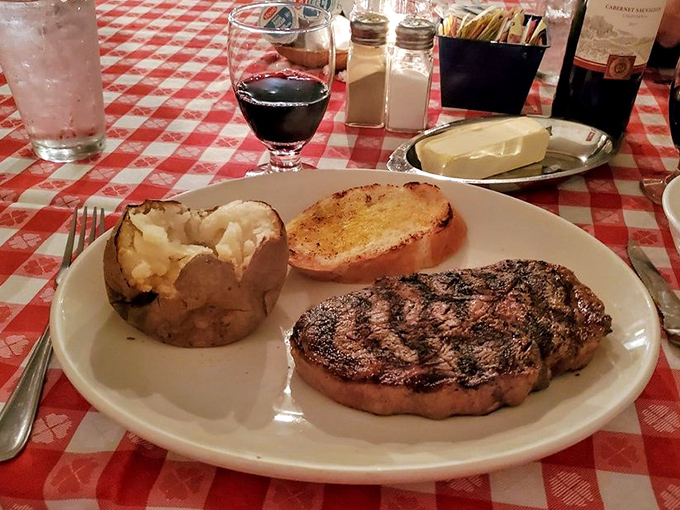 The star of the show in all its glory. A perfectly seared ribeye alongside a fluffy baked potato and golden Texas toast – the holy trinity of steakhouse perfection.