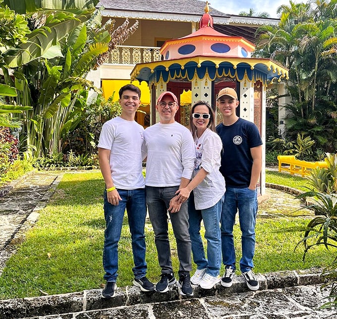The whimsical carousel pavilion provides the perfect backdrop for family memories, its vibrant colors rivaling the tropical foliage surrounding it.