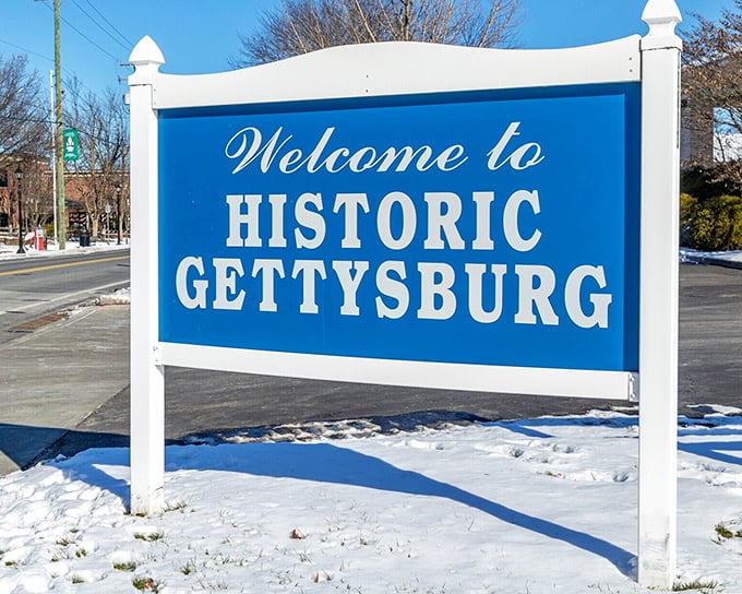 The iconic blue "Welcome to Historic Gettysburg" sign greets visitors with the promise of stepping into living history, where every street tells a story.