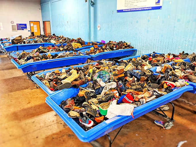 The famous blue bins of footwear—where one person's castoff cowboy boots become another's vintage fashion statement. Shoe heaven or chaos? Both!