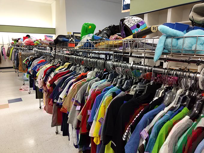 Rainbow rows of possibility—each tiny garment representing a child's adventure waiting to happen. Parenting on a budget never looked so colorful.