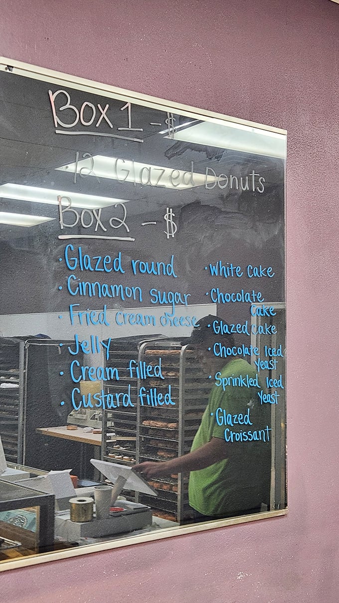 The handwritten menu board tells you everything you need to know: classics done right, from glazed rounds to cream-filled delights.
