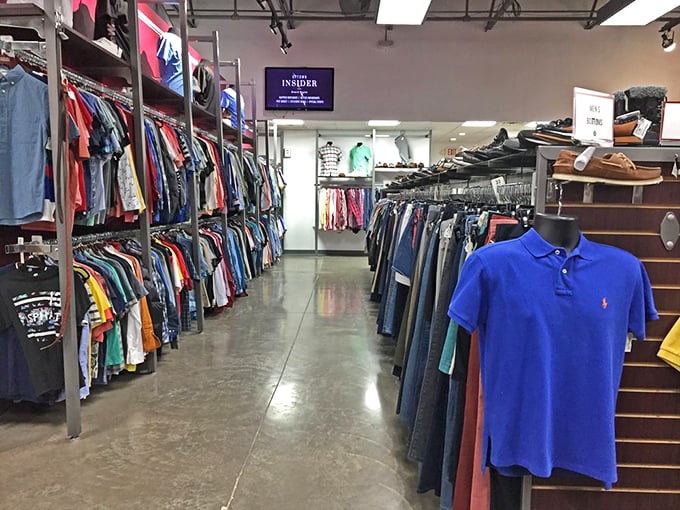 A rainbow of possibilities lines the polished concrete floors. That blue Ralph Lauren polo isn't just clothing—it's a designer steal waiting to happen.