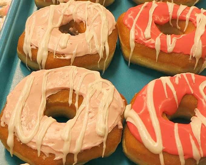 These pink and coral donuts aren't just breakfast—they're edible art. The drizzle pattern alone deserves its own exhibition at the Guggenheim.