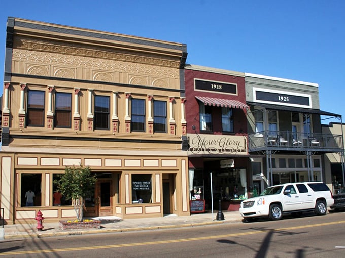 These storefronts wear their age like a badge of honor, each brick holding decades of reasonable retail therapy.