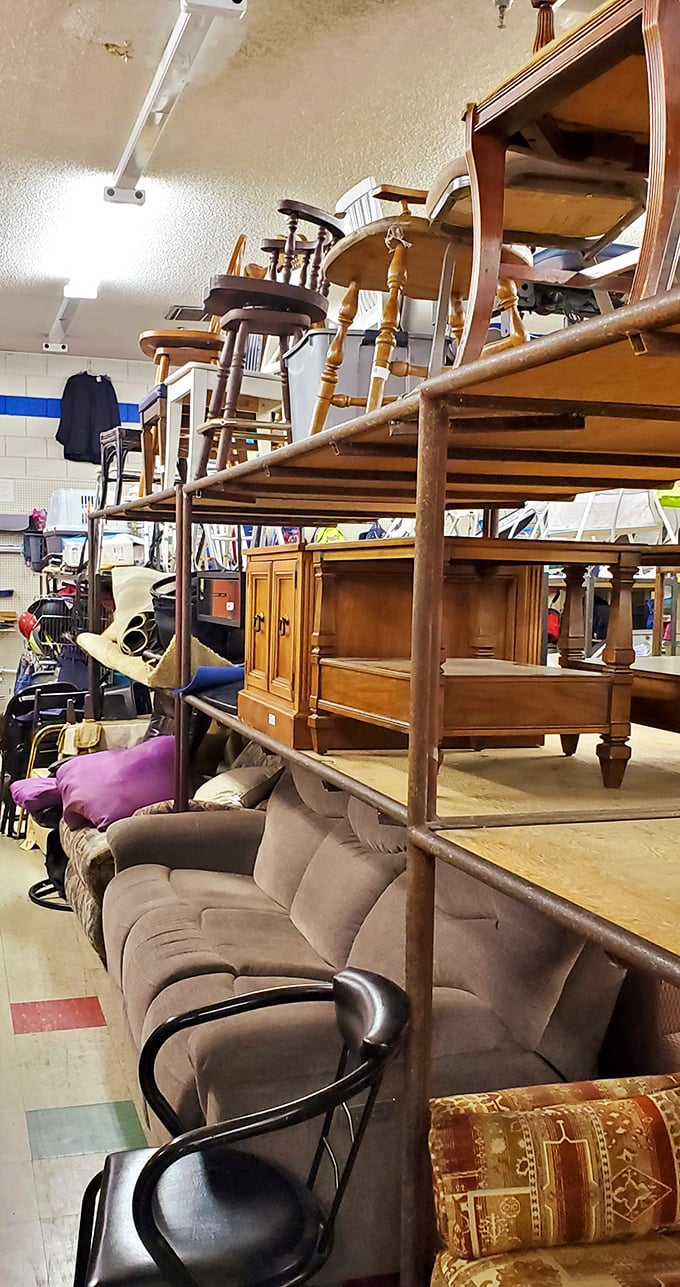 Furniture heaven or chair purgatory? Wooden thrones and comfy couches stacked like a game of secondhand Tetris, waiting for their forever homes.
