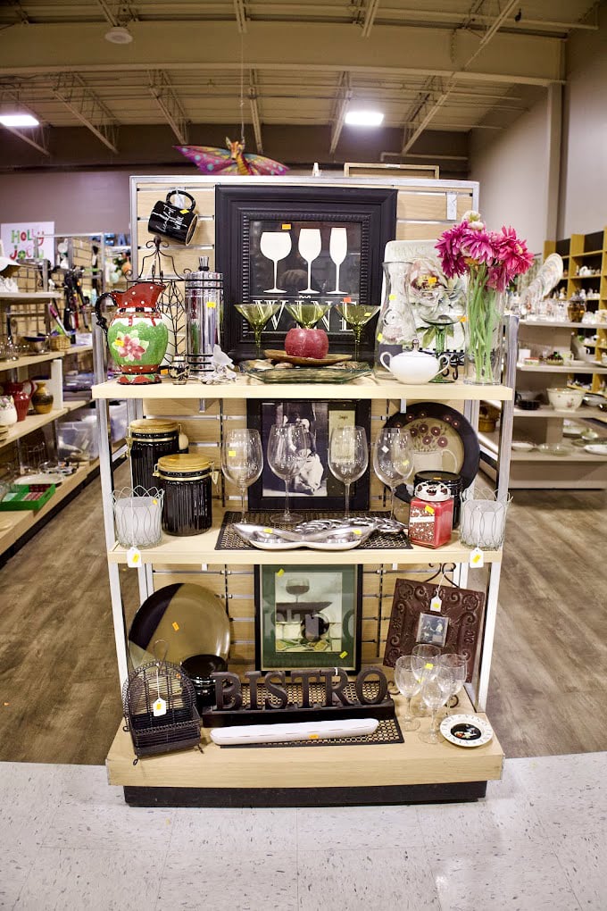 Wine glasses, decorative frames, and colorful accents—proof that one person's "I don't need this anymore" becomes another's "I can't believe I found this!"