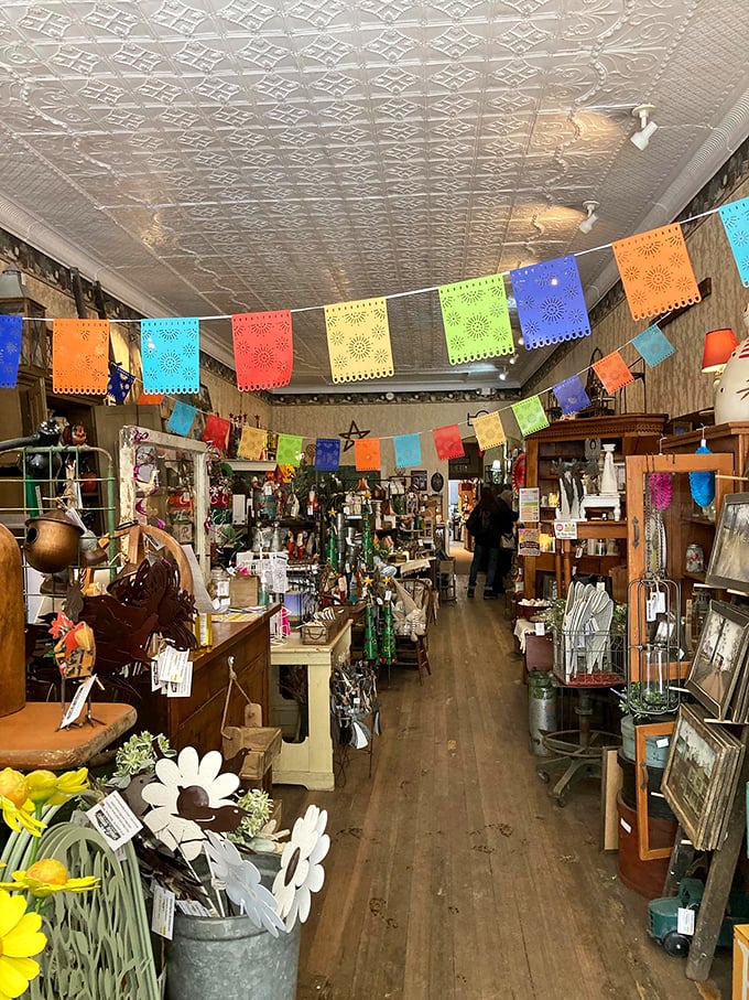 Colorful papel picado banners dance beneath original pressed tin ceilings, creating pathways through history that feel like walking through a living museum.