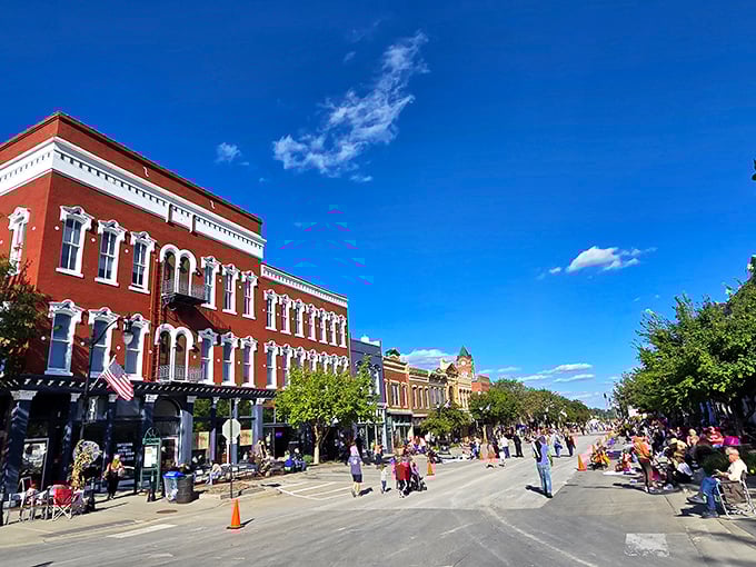 Main Street stretches toward the horizon like a scene from a nostalgic film, where red brick buildings frame a perfect small-town tableau.