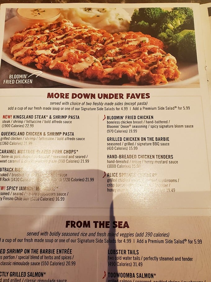 The menu reads like a passport to flavor country—Bloomin' Fried Chicken and Lobster Tails beckon from their glossy pages.