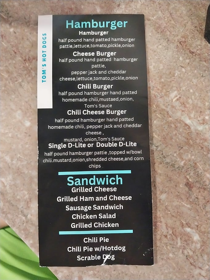 The menu board at Tom's doesn't need fancy descriptions—these are hot dogs with purpose, burgers with conviction, and sandwiches with integrity.