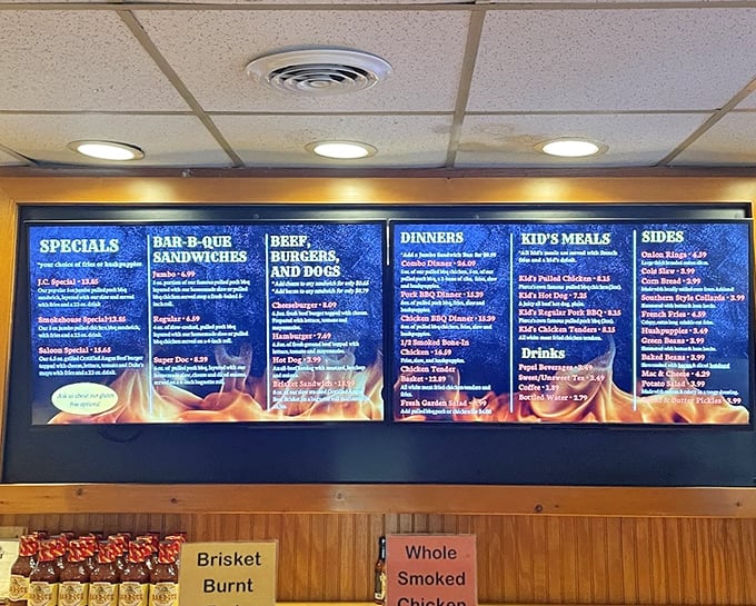 The menu board tells a story of barbecue devotion – no fancy fusion concepts here, just time-honored classics that have kept folks coming back for decades.