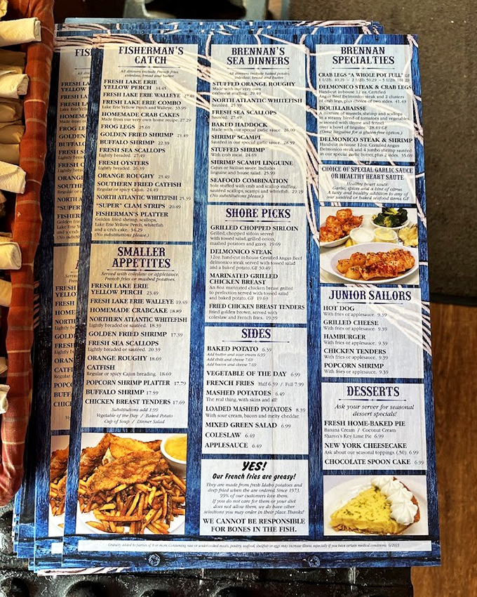 The legendary menu at Brennan's—a blue-bordered roadmap to seafood nirvana. Notice they proudly declare "Our French fries are greasy!" That's confidence you can taste.