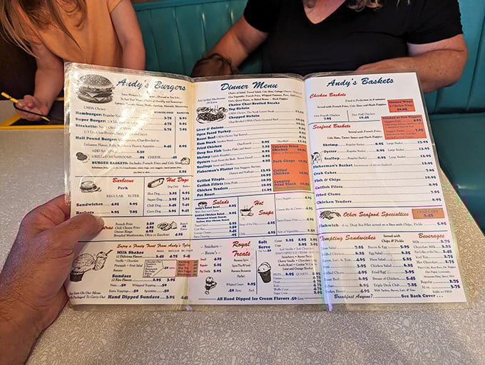 The well-worn menu tells tales of American comfort food classics—each page a roadmap to satisfaction that doesn't require GPS.
