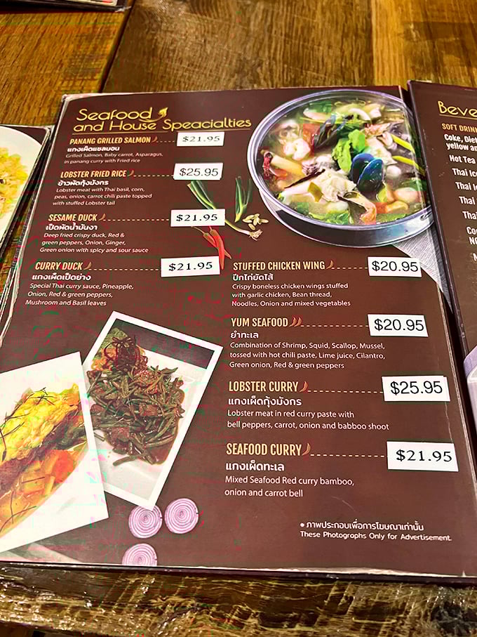 The menu reads like a love letter to Thai cuisine. Those little chili pepper symbols aren't just decoration—they're fair warning for your taste buds.