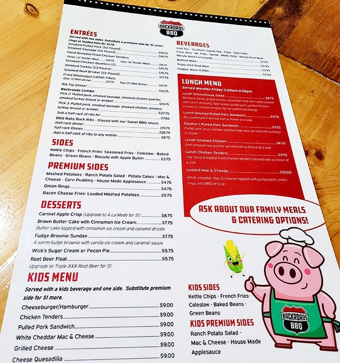A menu that reads like a love letter to smoked meats. The cartoon corn and pig mascots are just letting you know what's in store.