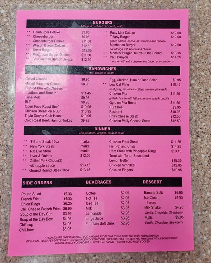 The legendary pink menu – a roadmap to happiness printed on paper. No QR codes here, just time-tested classics waiting to be discovered.