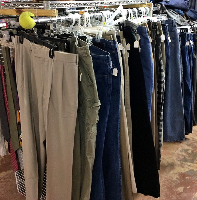 Pants galore hanging like a rainbow of possibilities, each pair with its own story to tell.