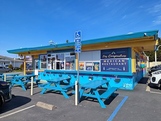 Los Compadres' vibrant blue exterior is like a beacon of flavor. Those picnic tables have hosted countless conversations between locals and visitors discovering authentic Mexican cuisine.