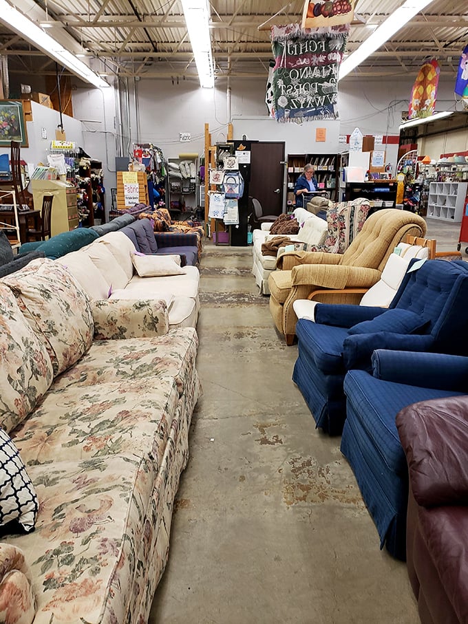 The sofa showroom resembles a living room family reunion—floral prints and navy blues gathering to discuss which lucky shopper will take them home.