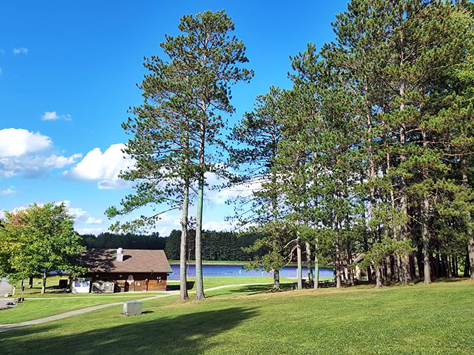Towering pines stand sentinel around rustic cabins and glassy waters. This isn't a Bob Ross painting—it's just another Tuesday at Parker Dam.
