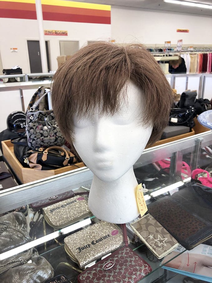 Not just any mannequin moment—this display showcases designer accessories beneath a perfectly styled wig.