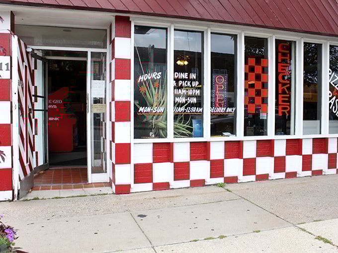That red and white checkerboard exterior isn't playing games – it's announcing serious pizza business with retro charm to spare.