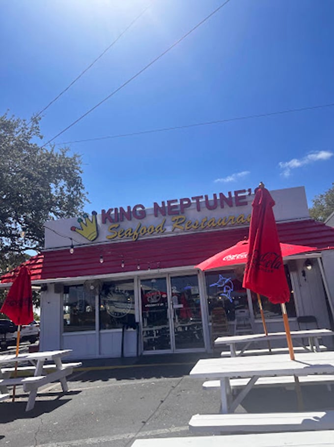 King Neptune's red umbrellas wave like flags declaring "serious seafood served here with serious smiles."