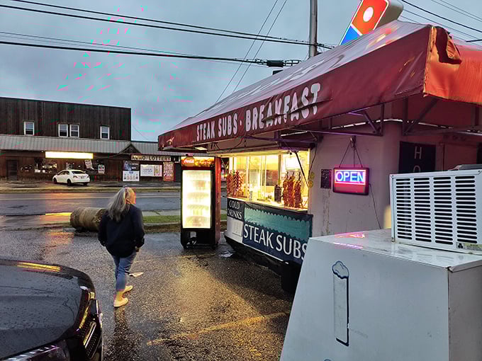 As dusk settles, this humble hot dog stand glows with promise, a beacon for those seeking late-night flavor adventures.