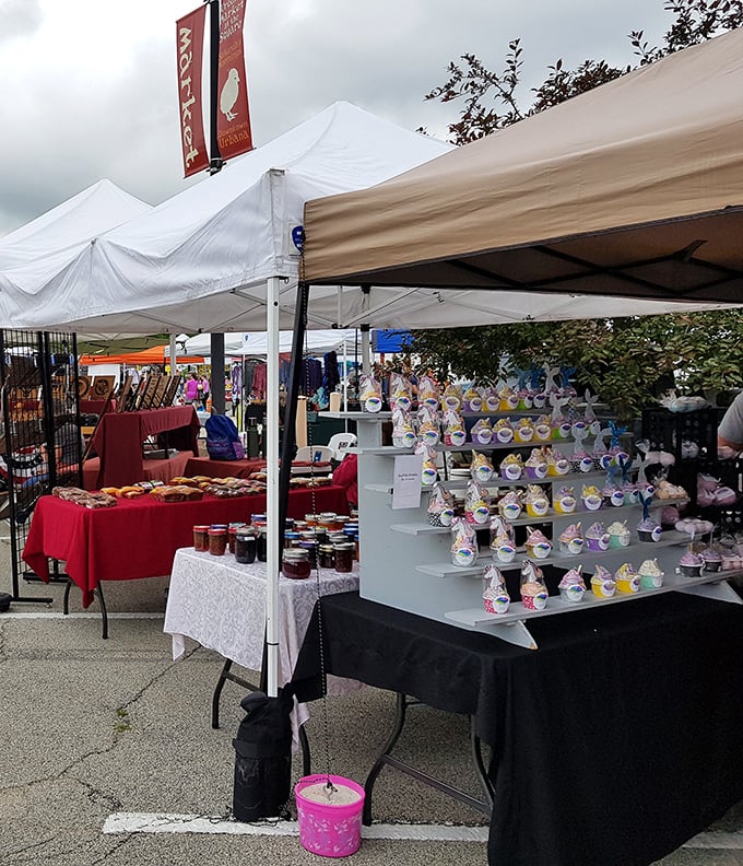 Sweet tooth heaven meets craft explosion! Red banner waves over homemade jams while colorful cupcake creations stand at attention like tiny soldiers of delight.